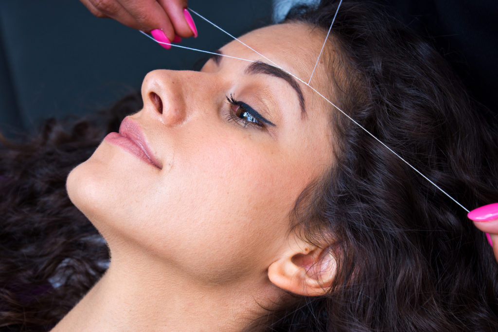 woman on facial hair removal threading procedure - Uplifting Mayhem woman on facial hair removal threading procedure - Uplifting Mayhem
